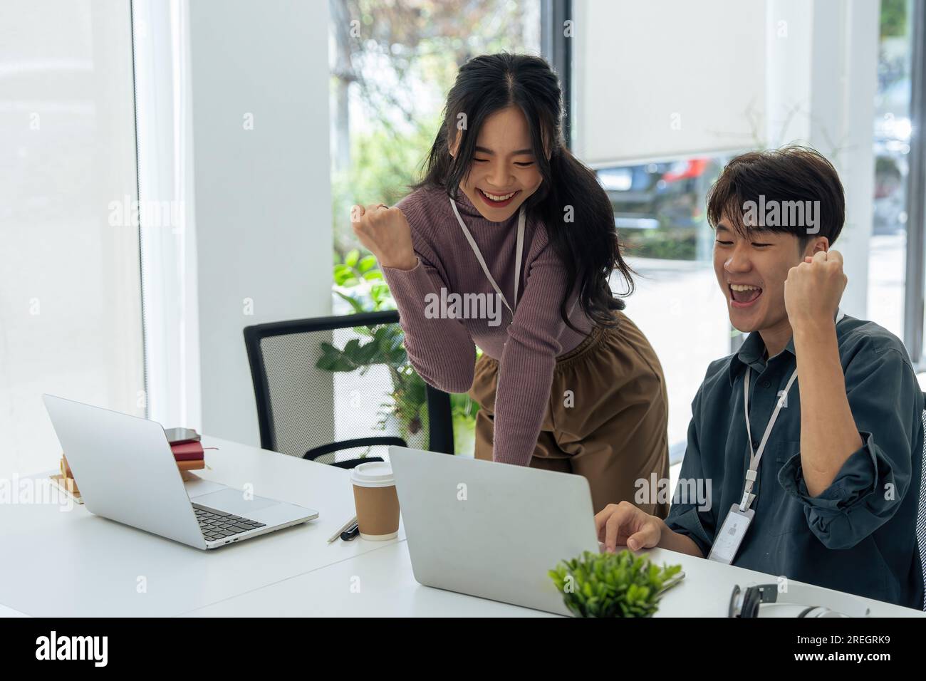 Success of happy employees smiling and laughing to celebrate project ...