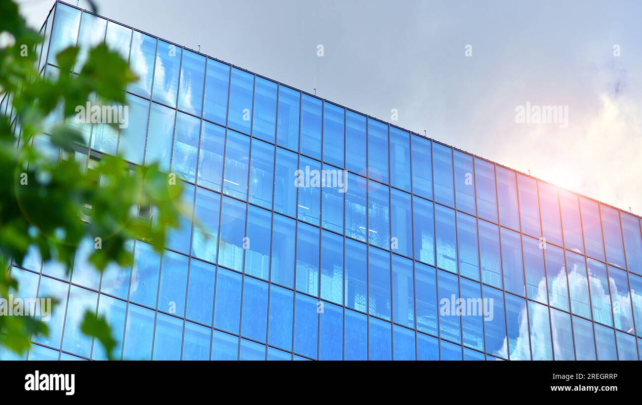 Reflection of modern commercial building on glass with sunlight. Eco ...