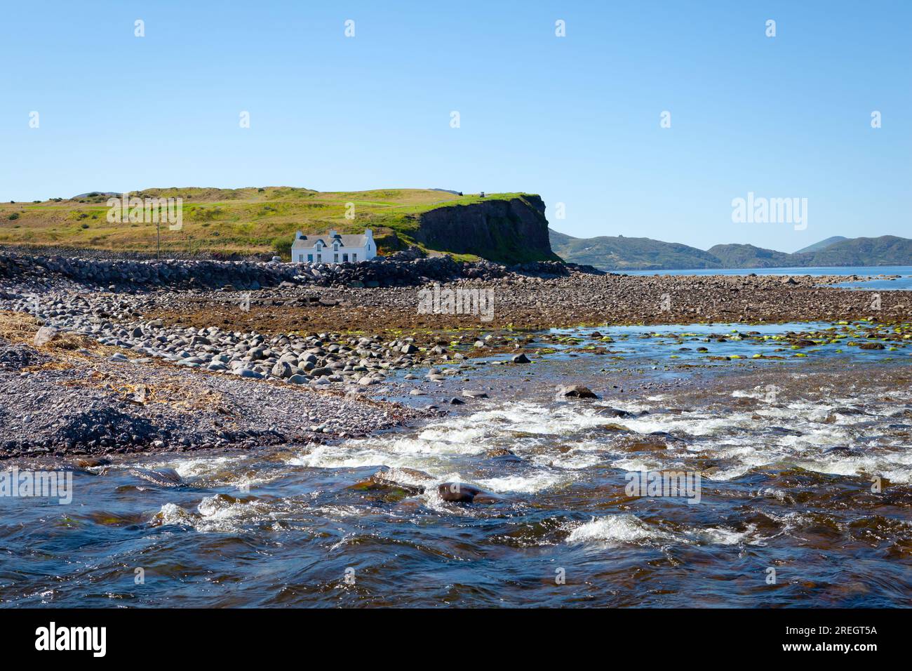 Lone cottage at the mouth of the Currane river on the waterfront at ...