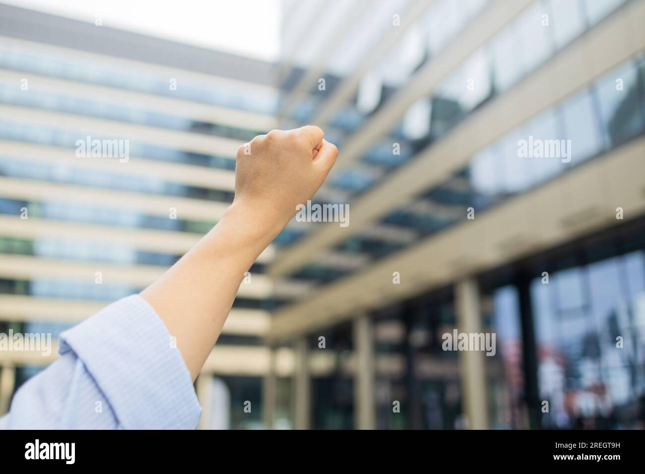 Close up bottom view of womans hand lifted a thumbs up symbol fist ...