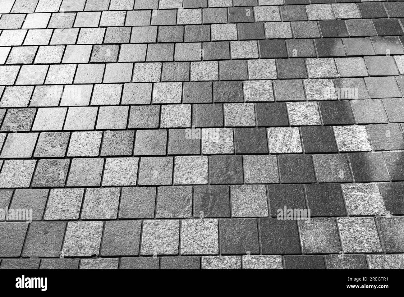 Gray cobblestone footpath. Tile background Stock Photo - Alamy