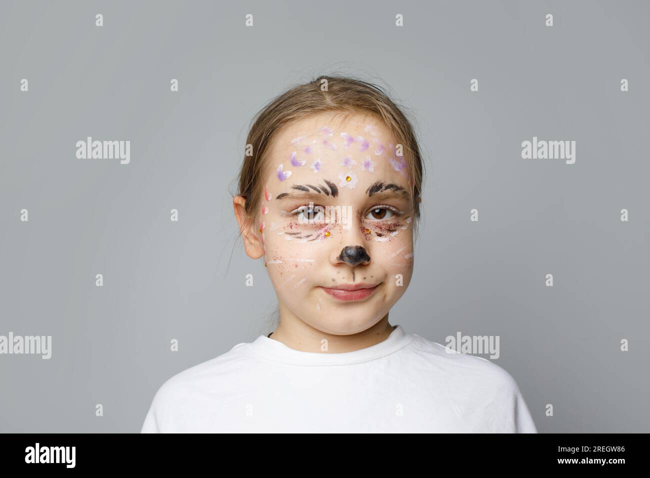 Face painting. Child with paint on face on grey background Stock Photo ...