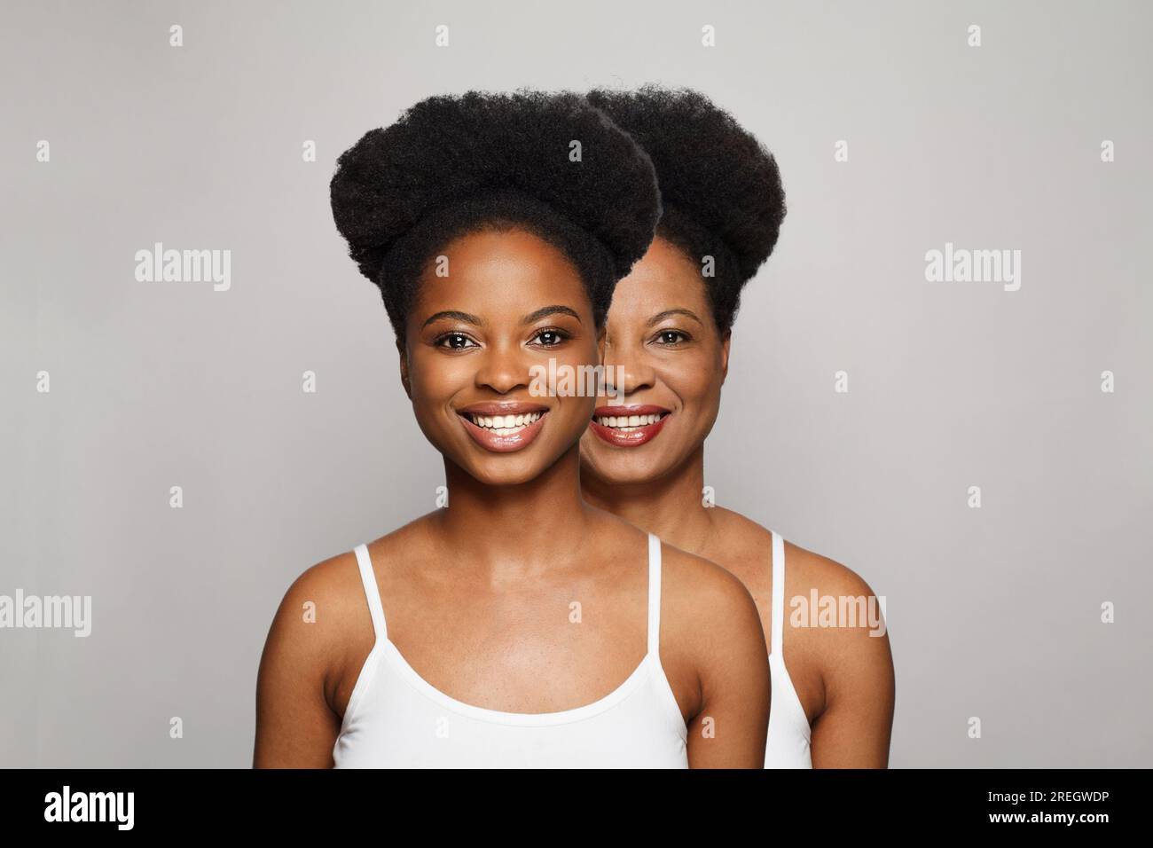 Healthy female models. Two women studio portrait. Young and senior face ...