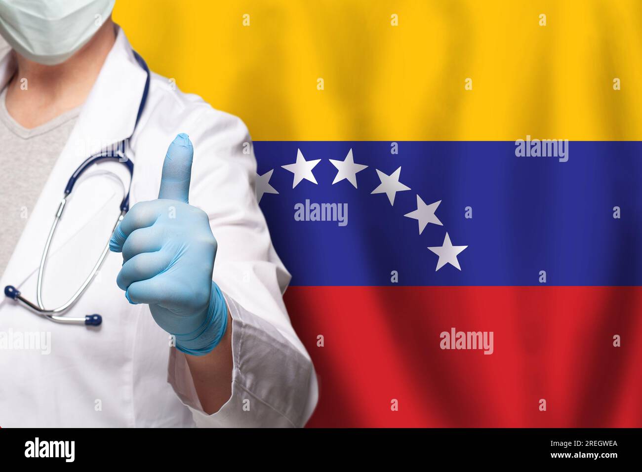 Venezuelan doctor's hand showing thumb up positive gesture on flag of ...