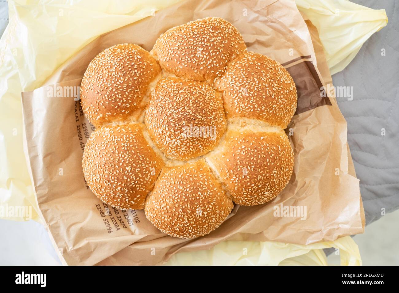 Photograph of a loaf of bread that can be torn apart into rolls, topped ...