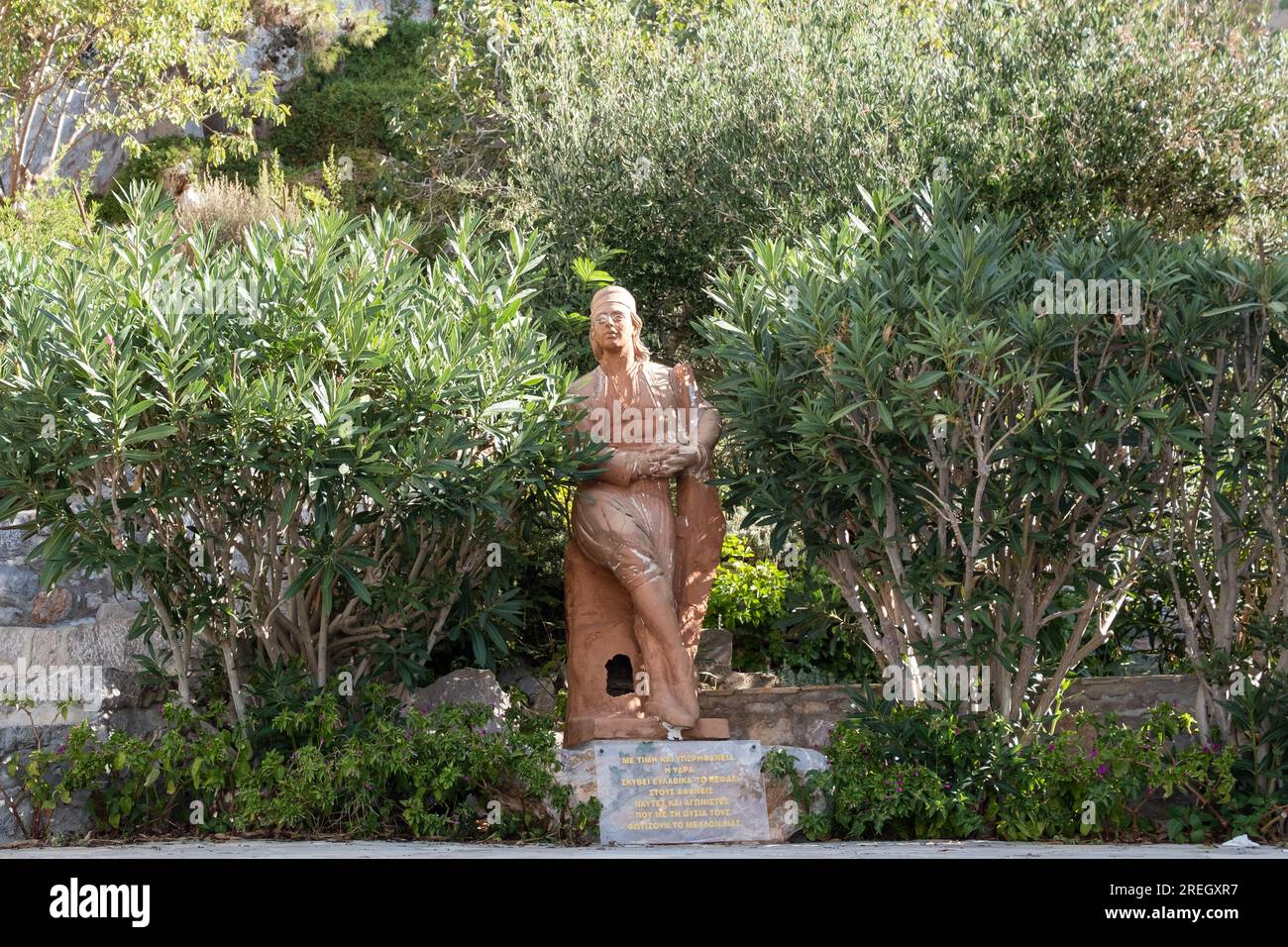 Statue by the port in Hydra, Greece, showing the terracotta-coloured ...