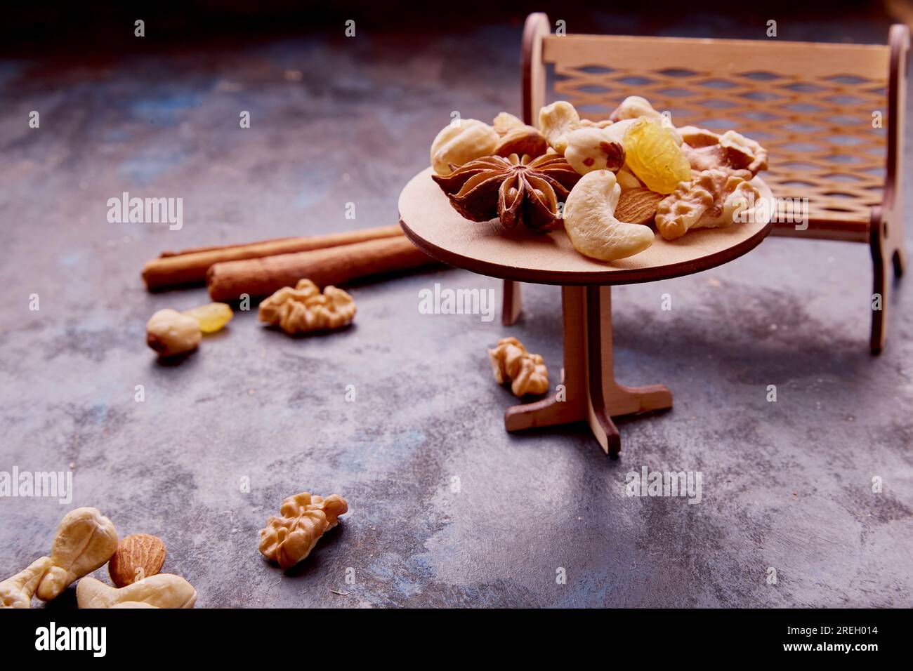 Decorative serving of mixed nuts on small furniture. Healthy desserts ...