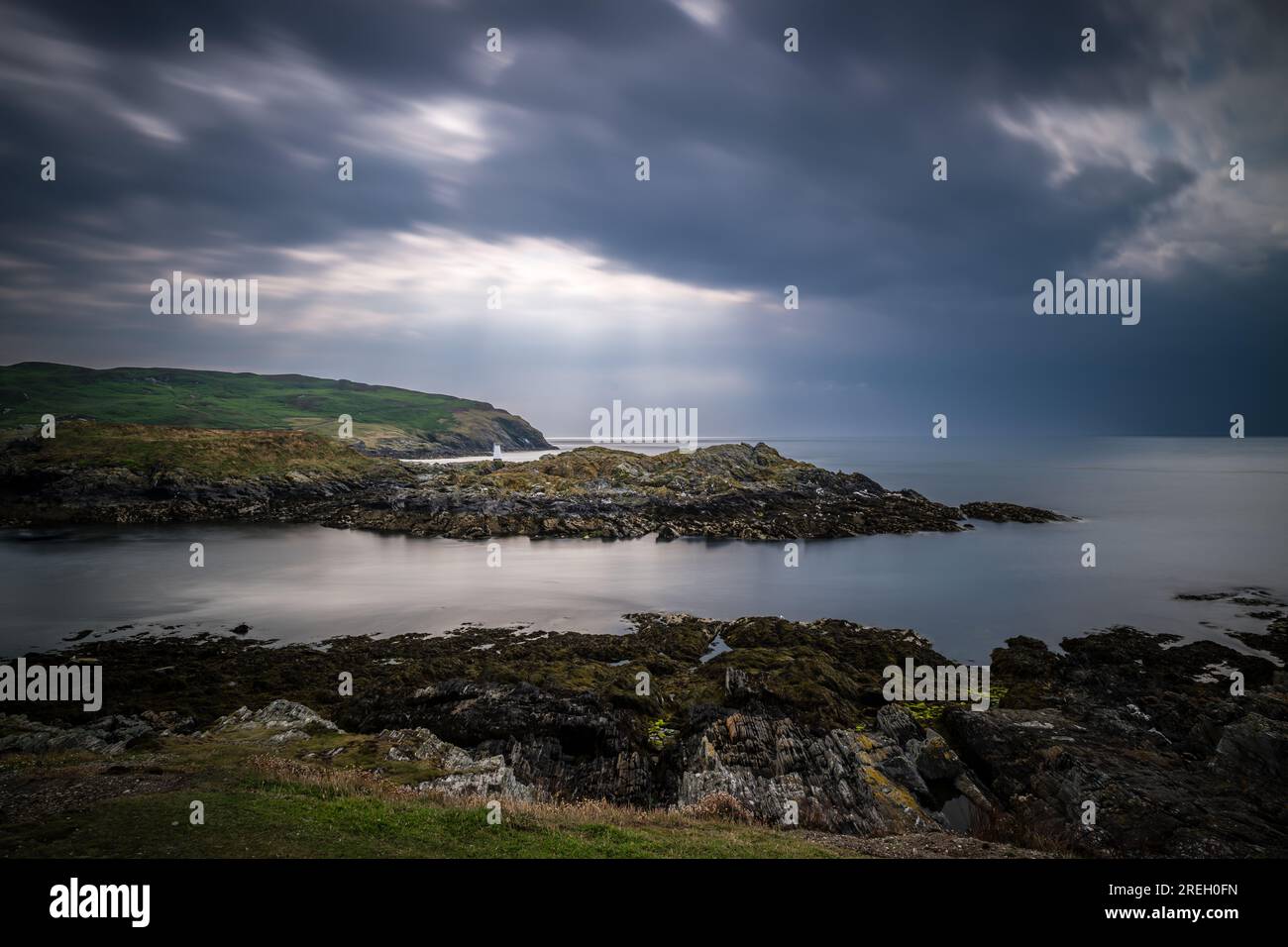 The last of the afternoon sun breaks through the clouds overlooking ...