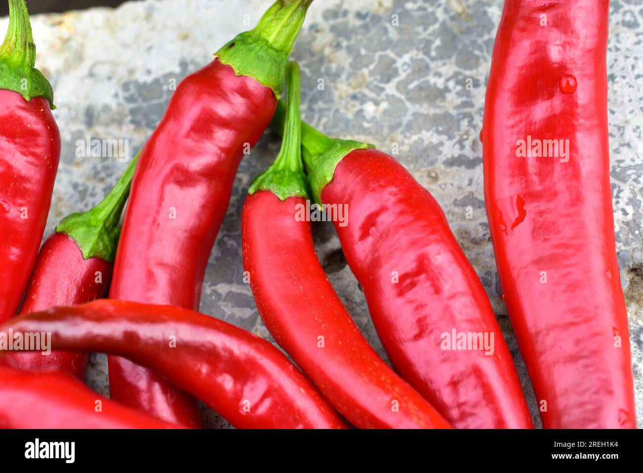 Lots of red fresh chili peppers on the concrete floor Stock Photo - Alamy