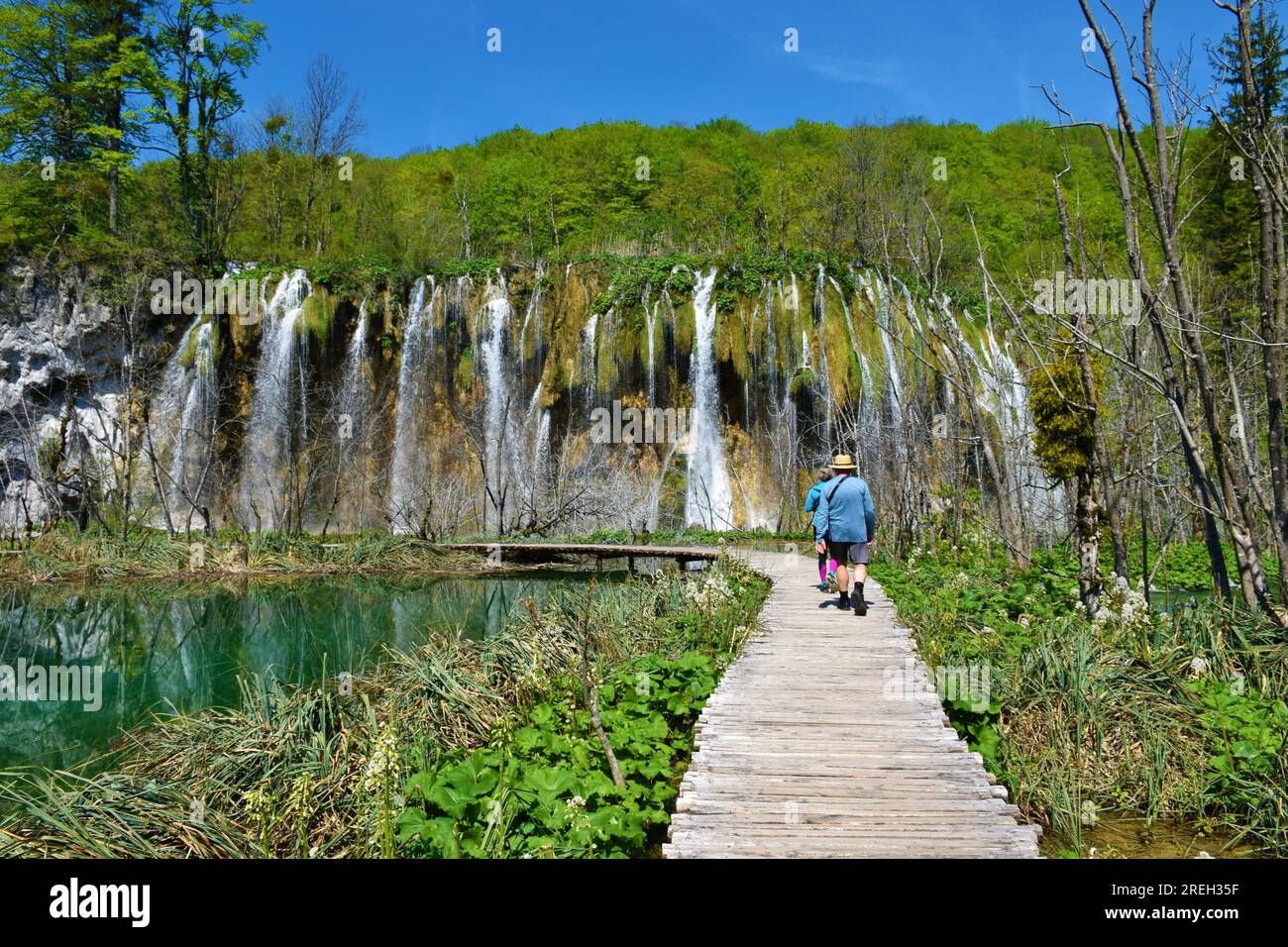 View of Mali Prštavac waterfall with people walking on the wooden ...