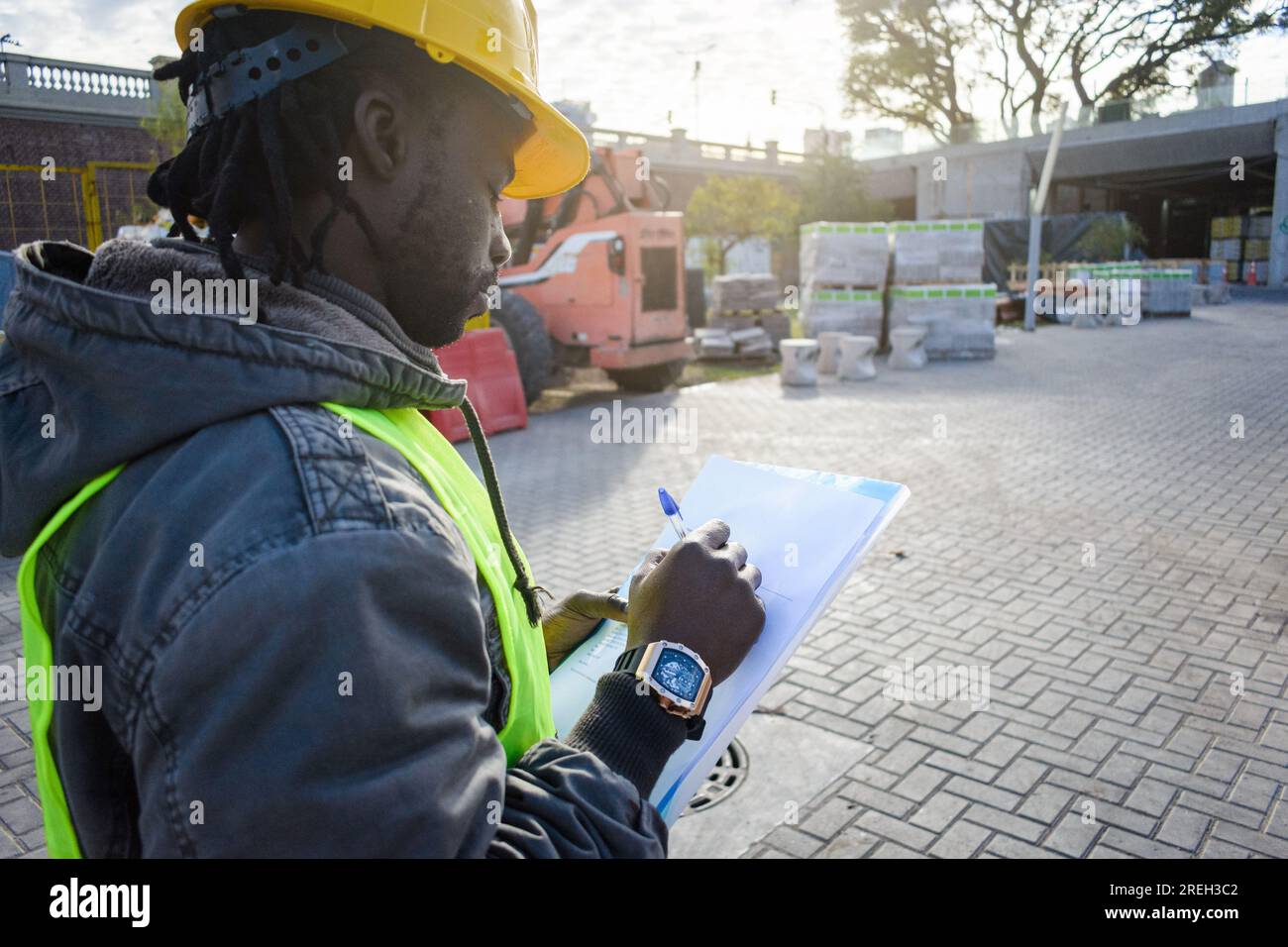 african ethnicity man engineer, wearing yellow safety helmet and ...