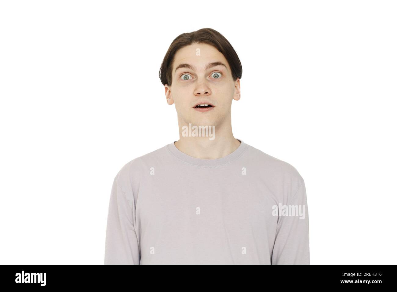 Shocked surprised young guy looking at camera isolated on white ...