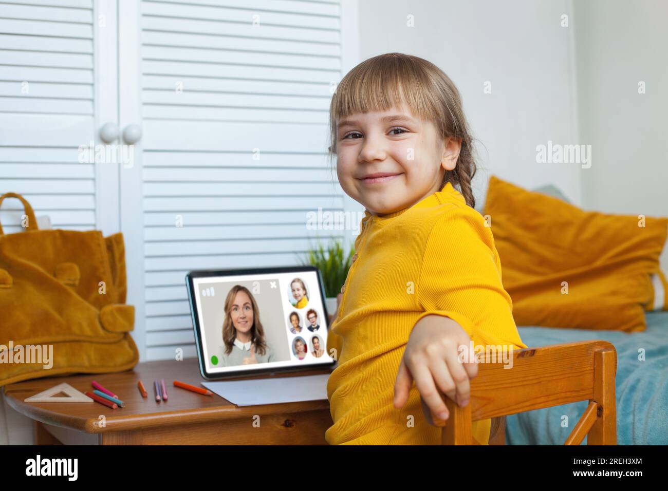 Happy young girl learning language online, using tablet gadget doing ...