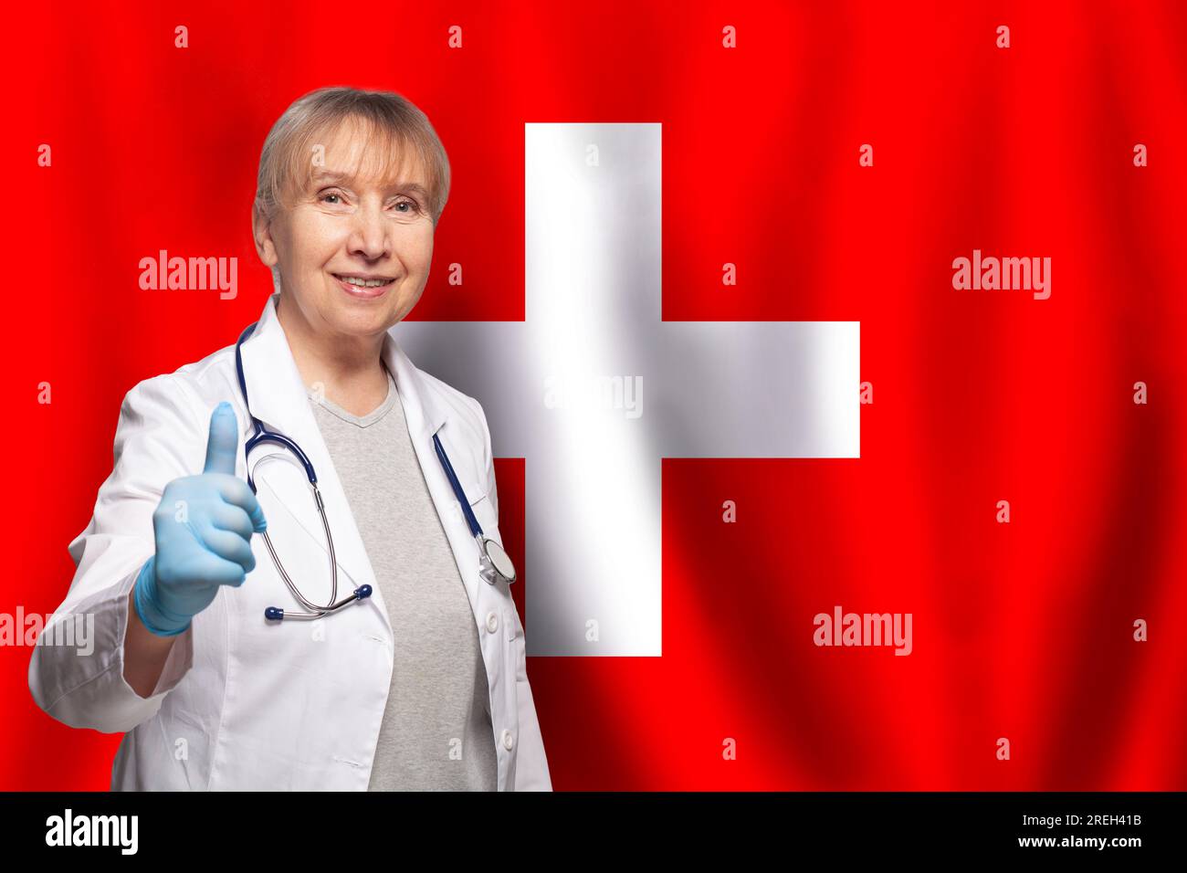 Swiss smiling mature doctor woman holding stethoscope on flag of ...
