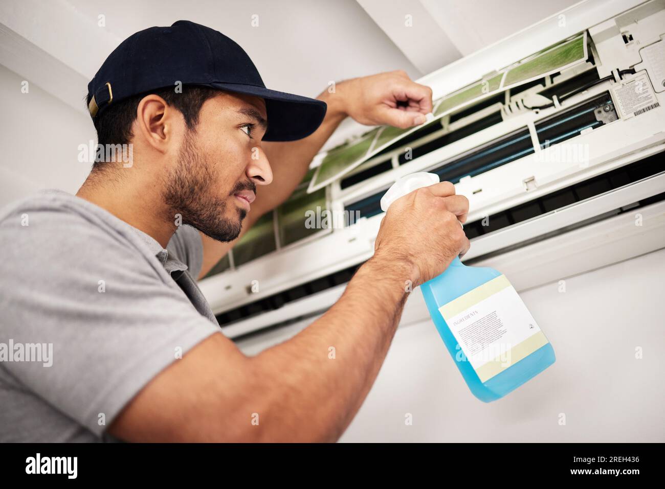 Air conditioner, cleaning and man with electrical machine check in a ...