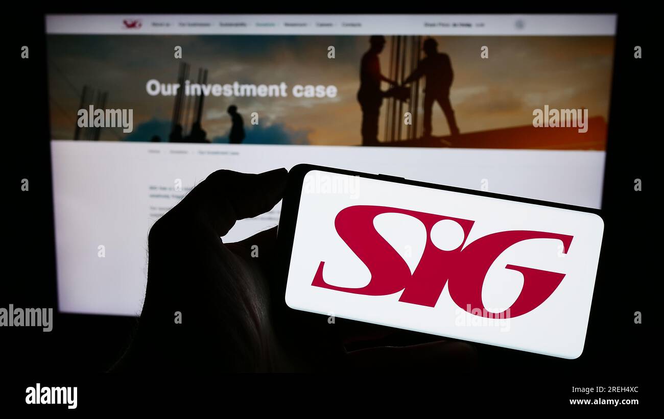 Person holding cellphone with logo of British building materials ...