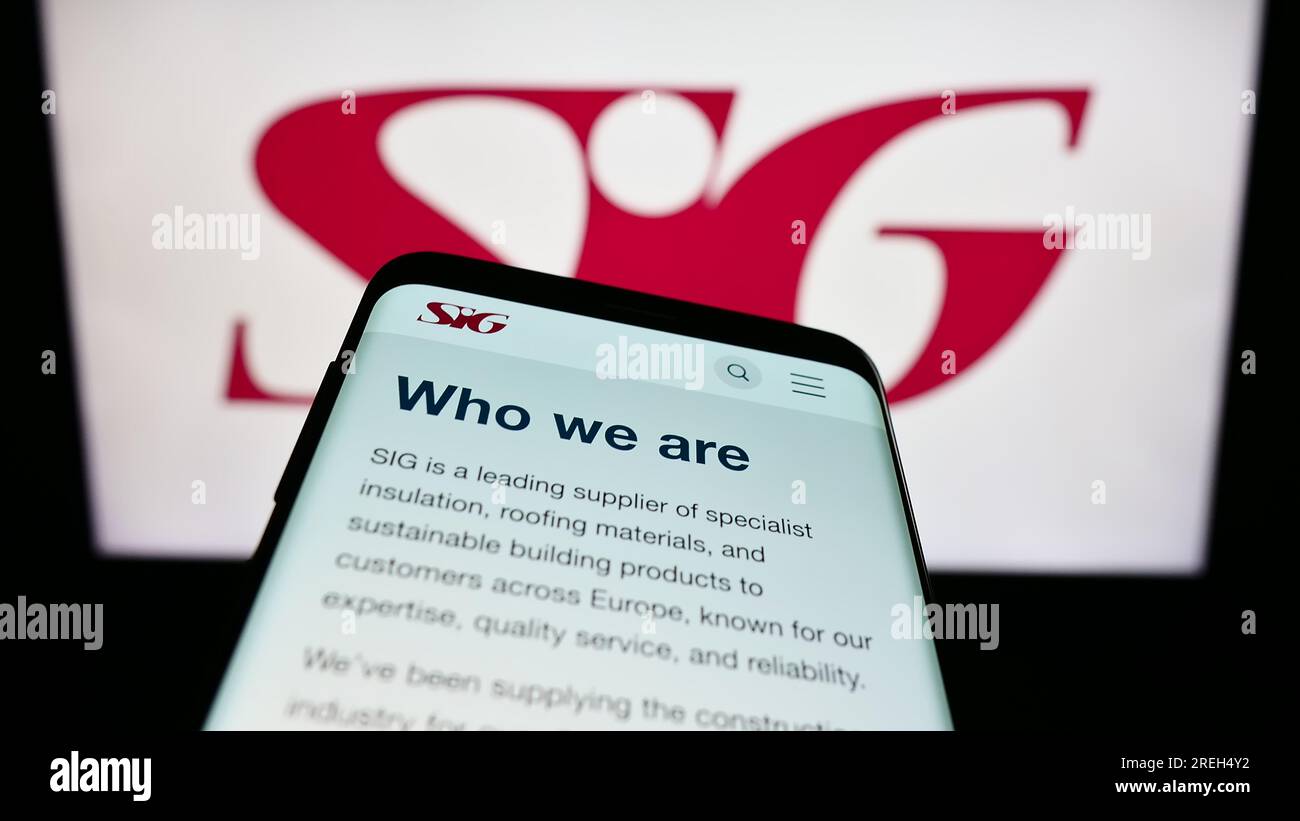 Mobile phone with website of British building materials company SIG plc on screen in front of ...