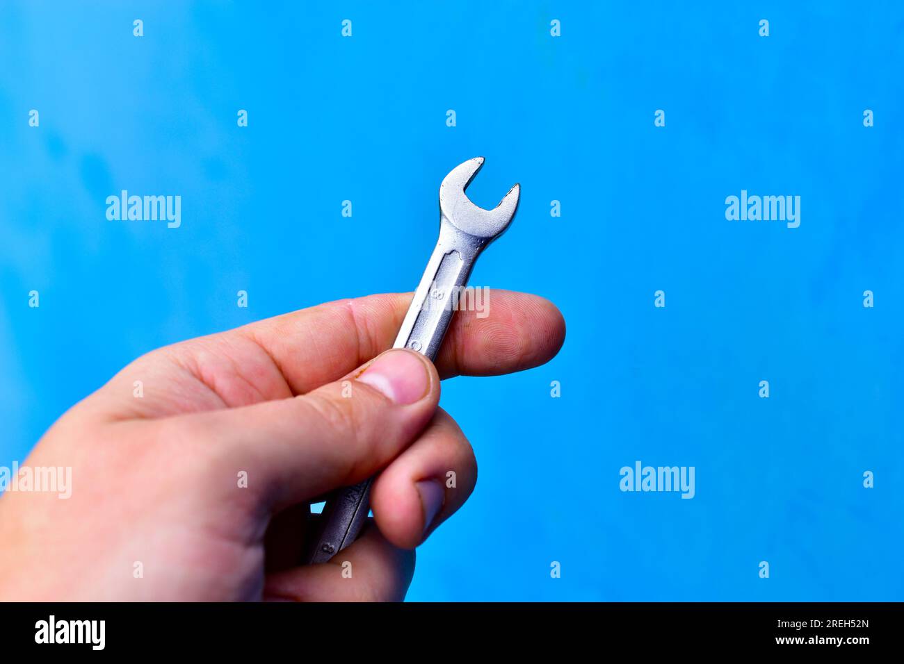 Metal shiny horn keys in the hand of the master Stock Photo - Alamy