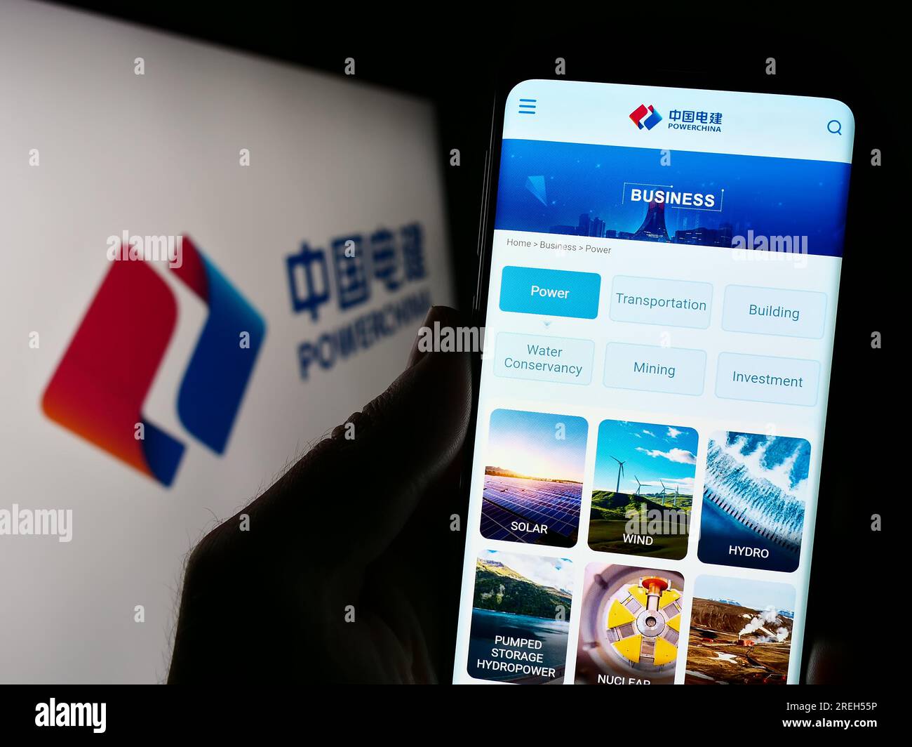 Person holding smartphone with webpage of Chinese energy company ...