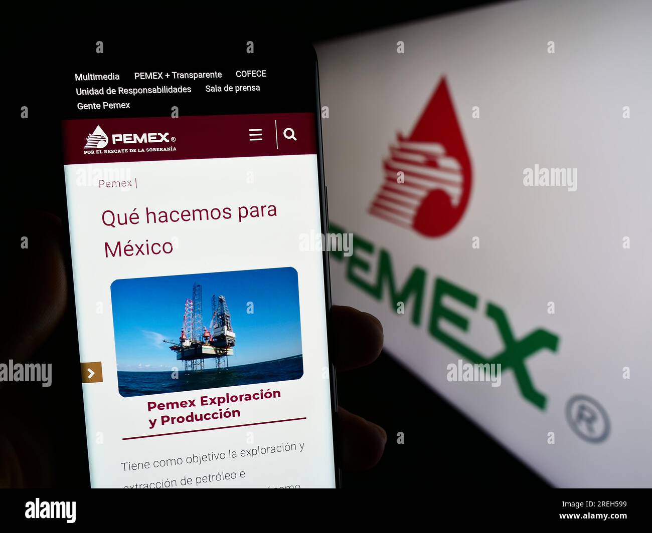 Person holding smartphone with web page of oil company Petroleos ...