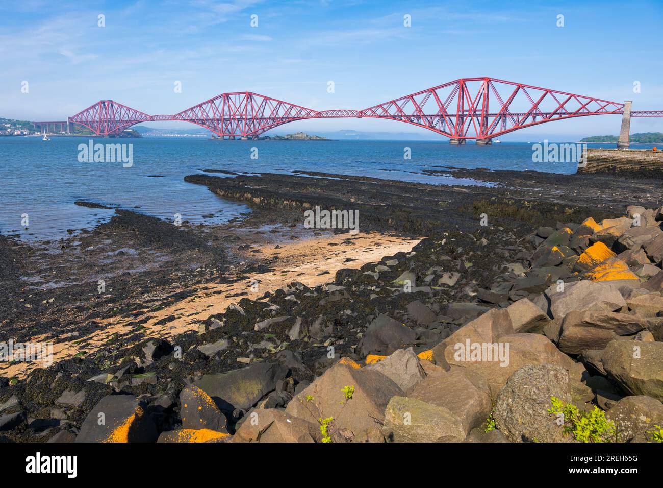 The Forth Bridge across Firth of Forth estuary from the shore in South ...