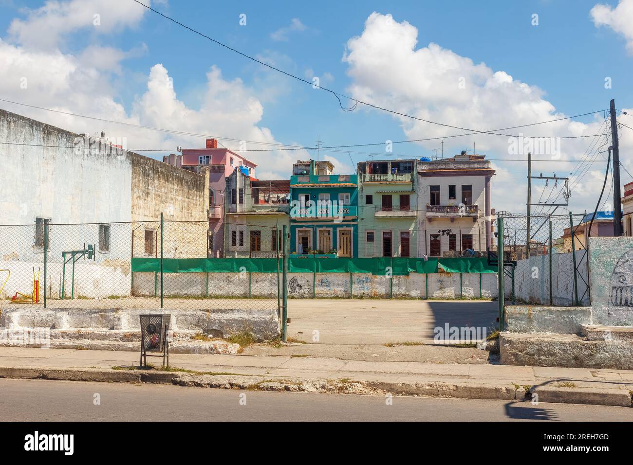 Havana, Cuba, An empty space with a fence. Facade of old buildings in ...