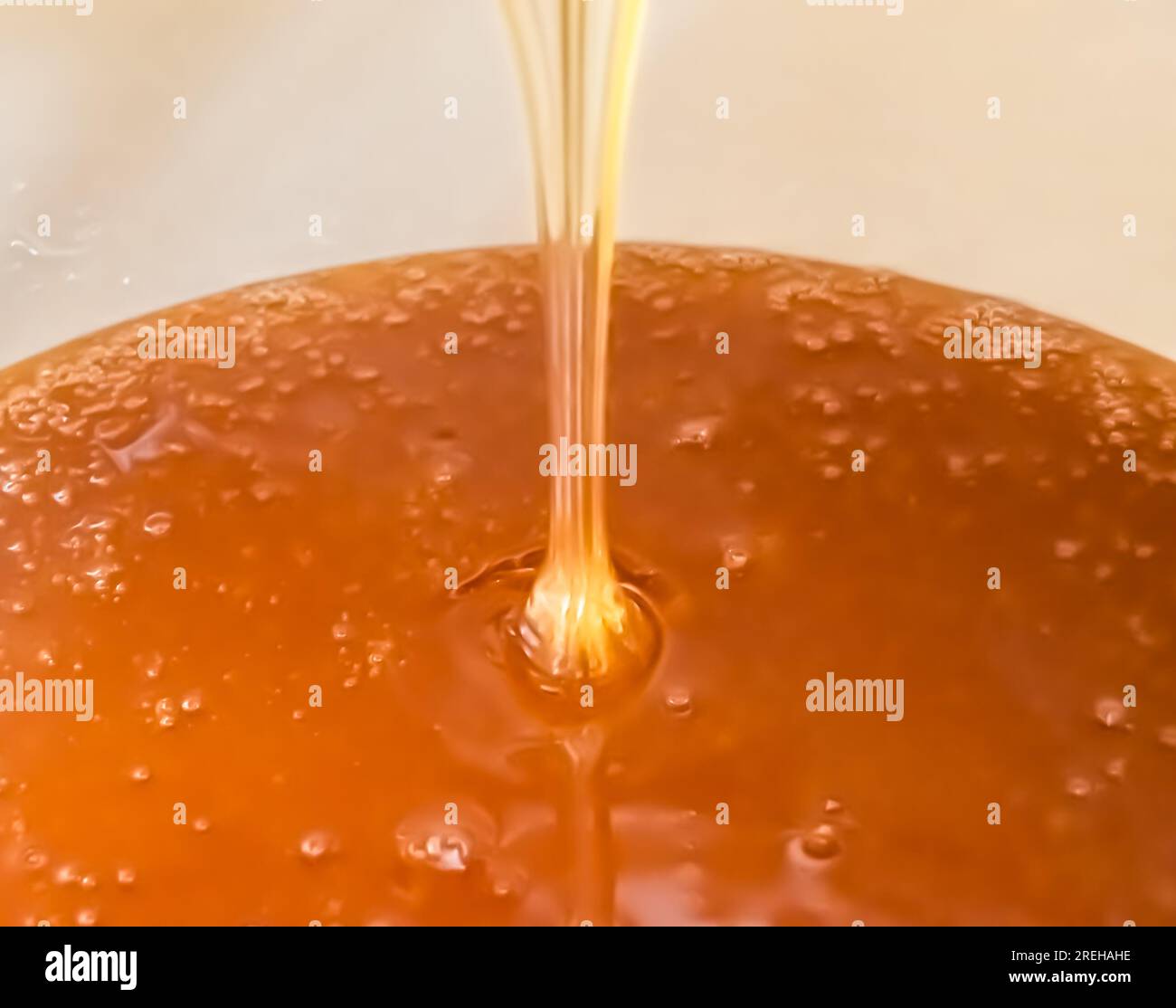 Drop of bee honey drip from hexagonal honeycombs filled with golden ...