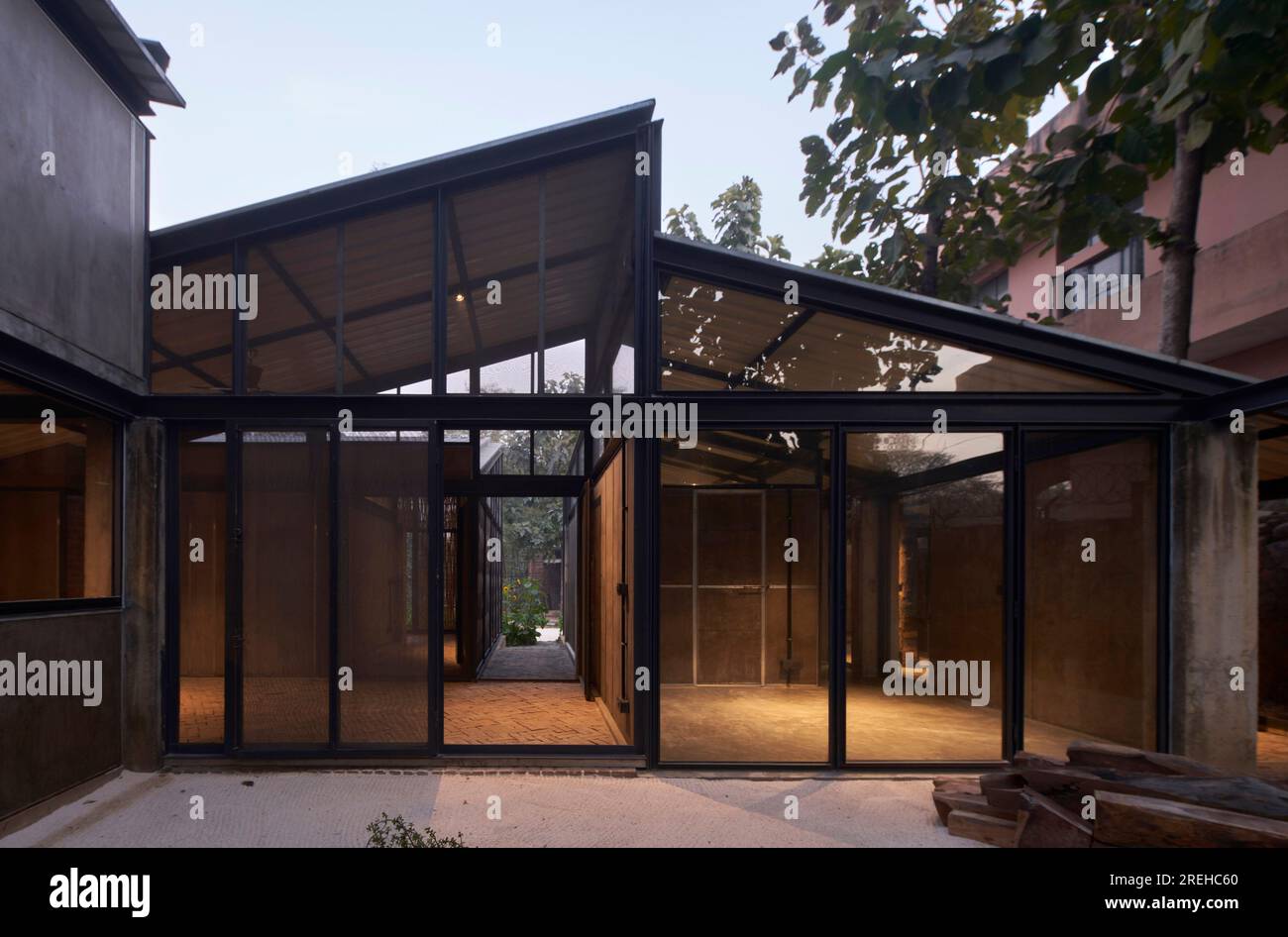 Front view of building rear at dusk. Farm8, New Delhi, India. Architect ...