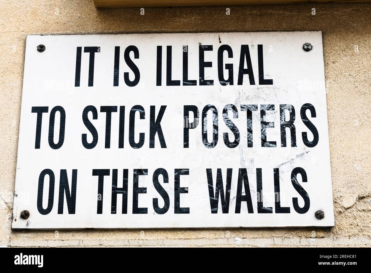 Illegal to stick posters on these walls sign in Bristol Stock Photo - Alamy
