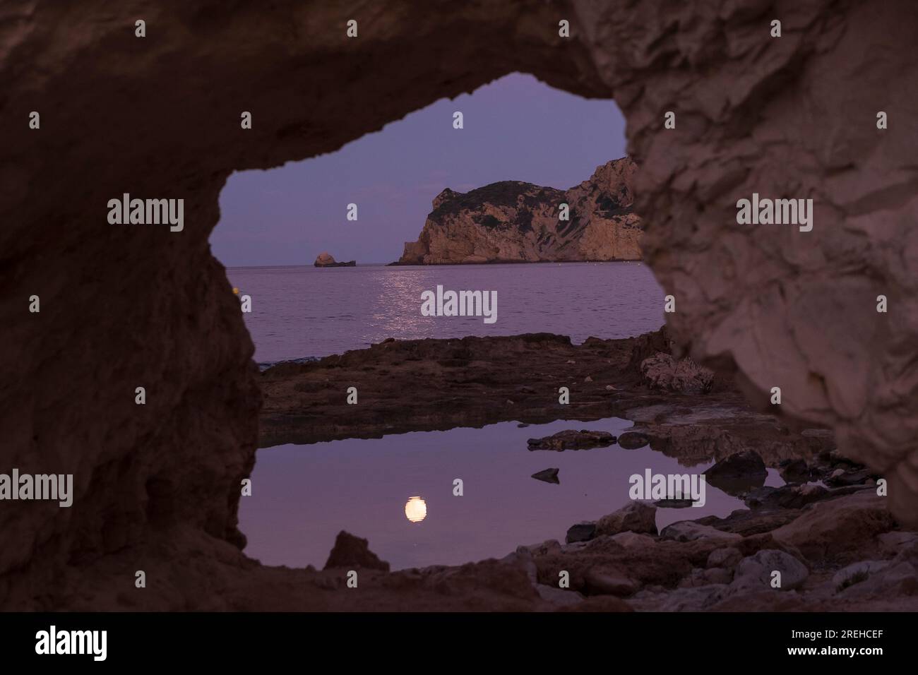 Full moon at the Cala Blanca in Javea. View of the Cap Prim Stock Photo ...