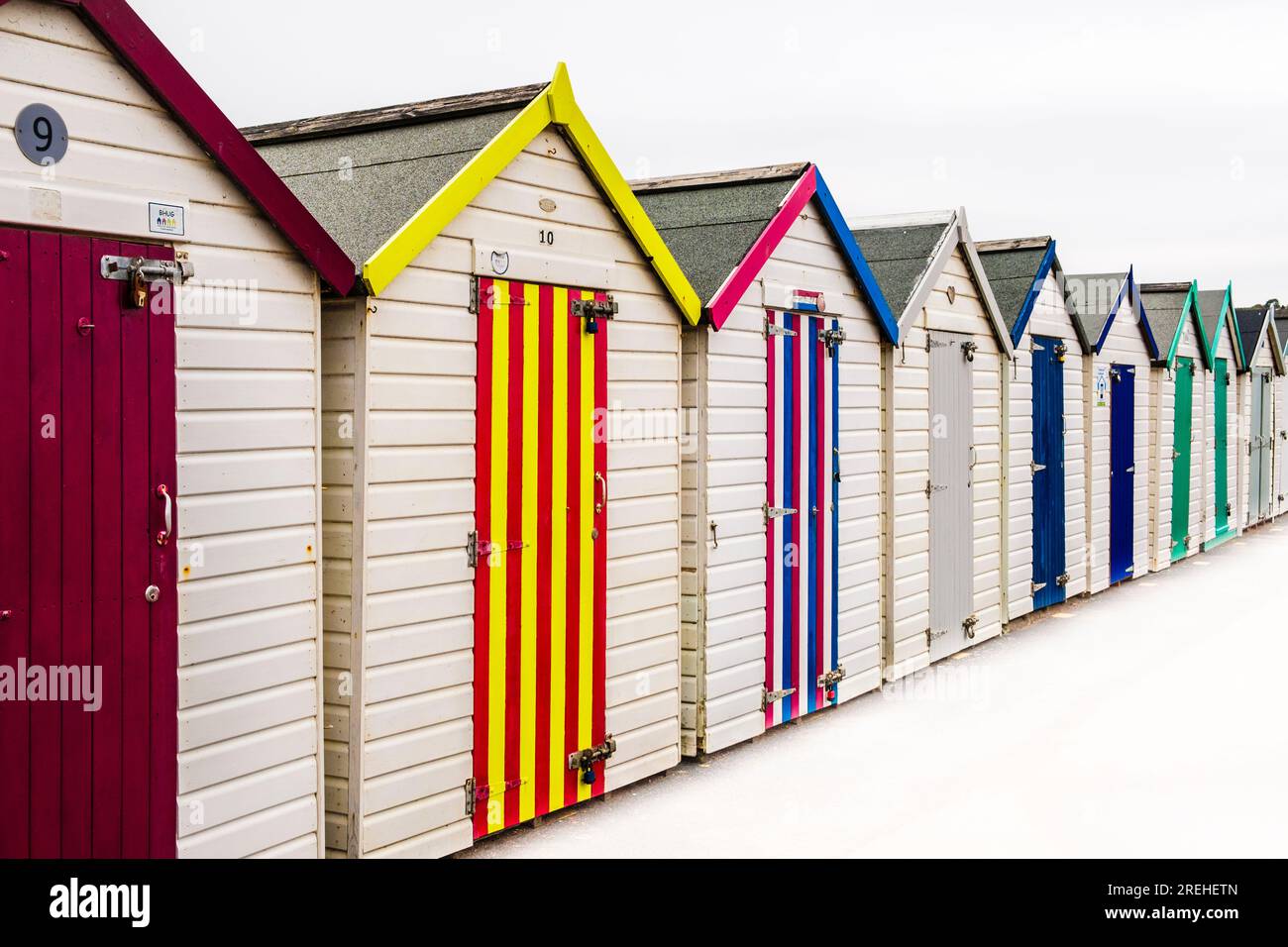 Beach huts with colourful doors on the seafront. Paignton, Devon ...