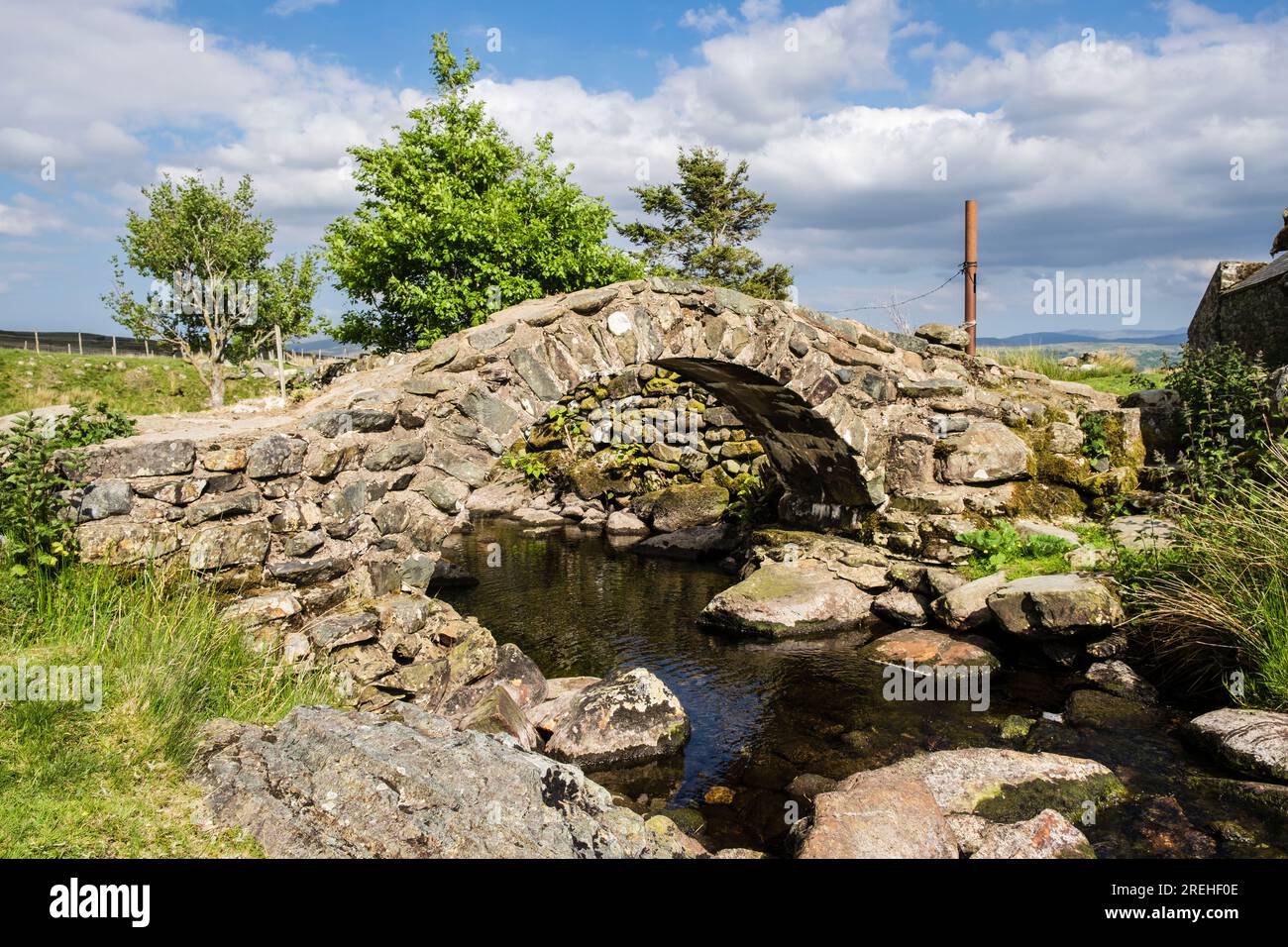 Quaint old footbridge over Afon Crawcwellt river in the Rhinogs valley ...