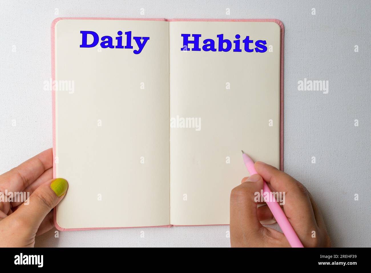 Diary in hand . Daily Habits text or word written on it Stock Photo - Alamy