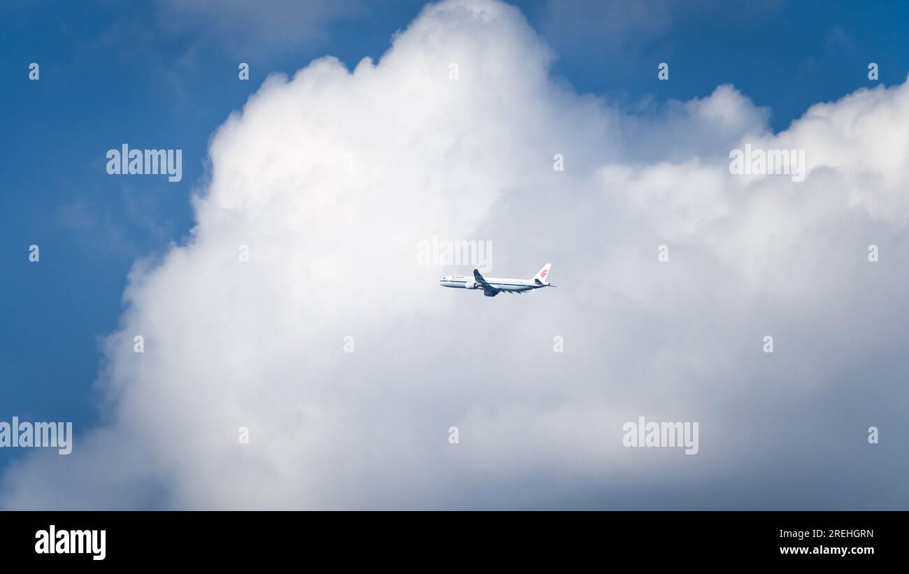 The plane that travels through the clouds Stock Photo - Alamy