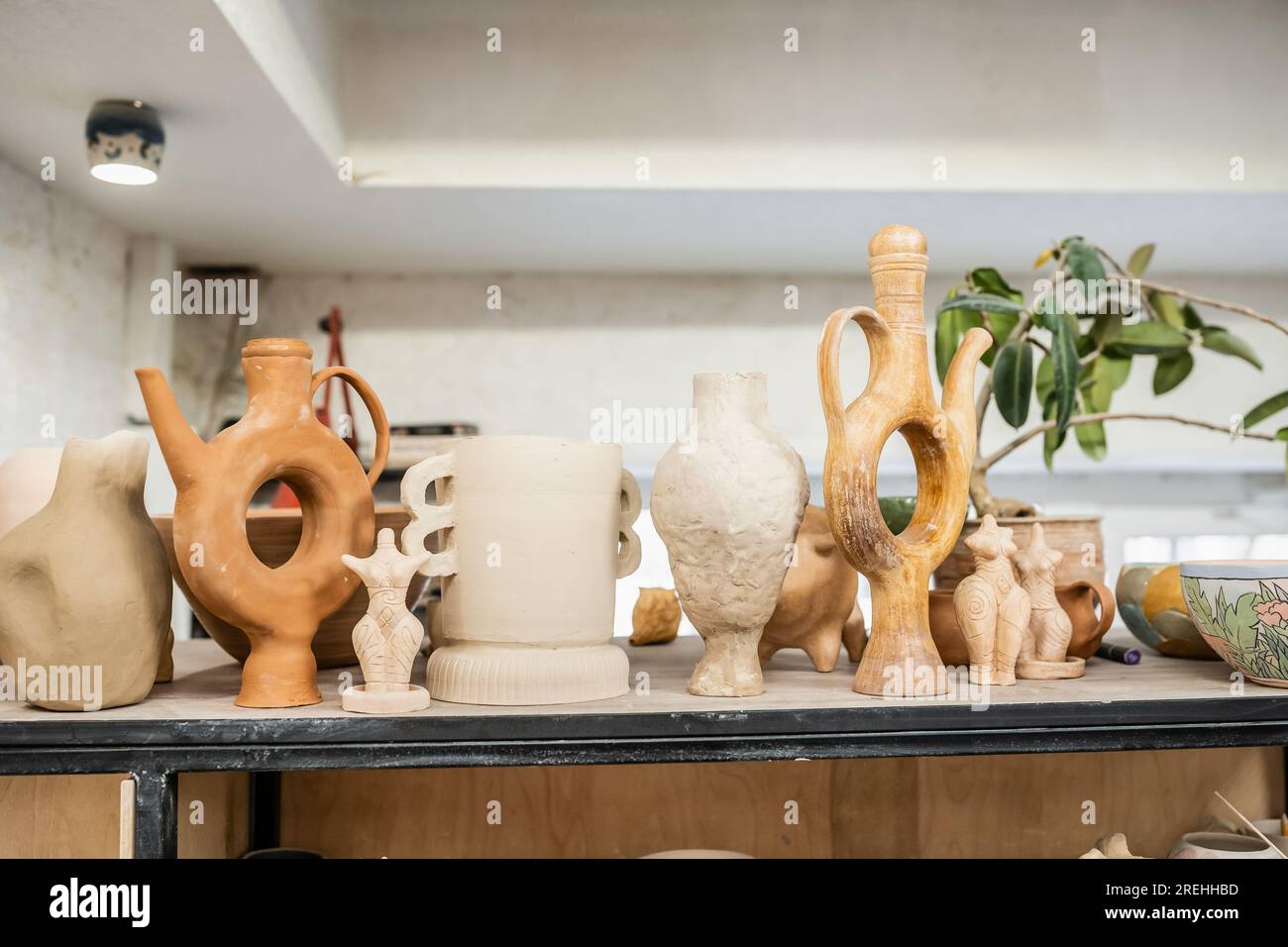 Clay figures and sculptures on rack in blurred ceramic workshop Stock ...