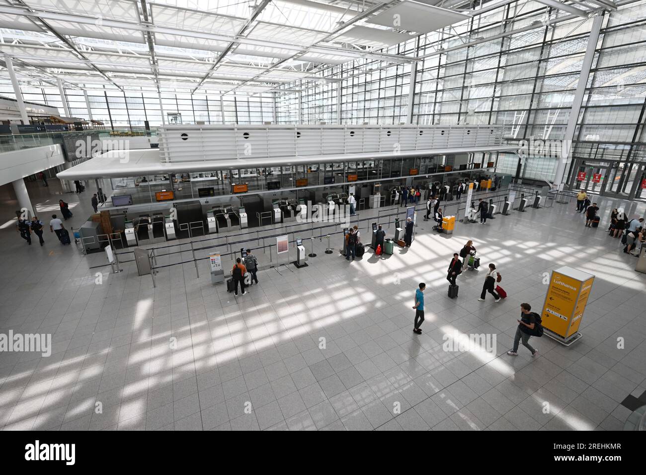 Munich, Germany. 28th July, 2023. Travelers check in their baggage at ...