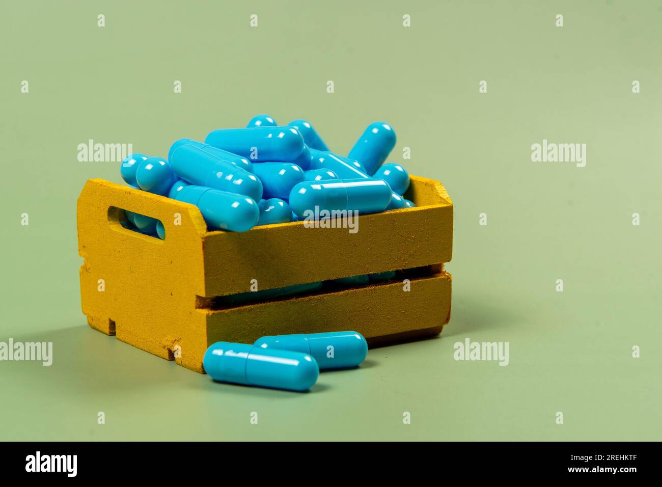 blue medicine capsule in yellow delivery box Stock Photo - Alamy