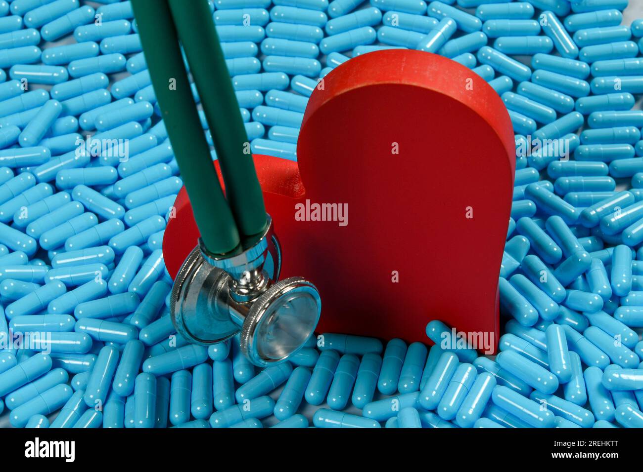 heart shape and medicine capsules representing heart problems and ...