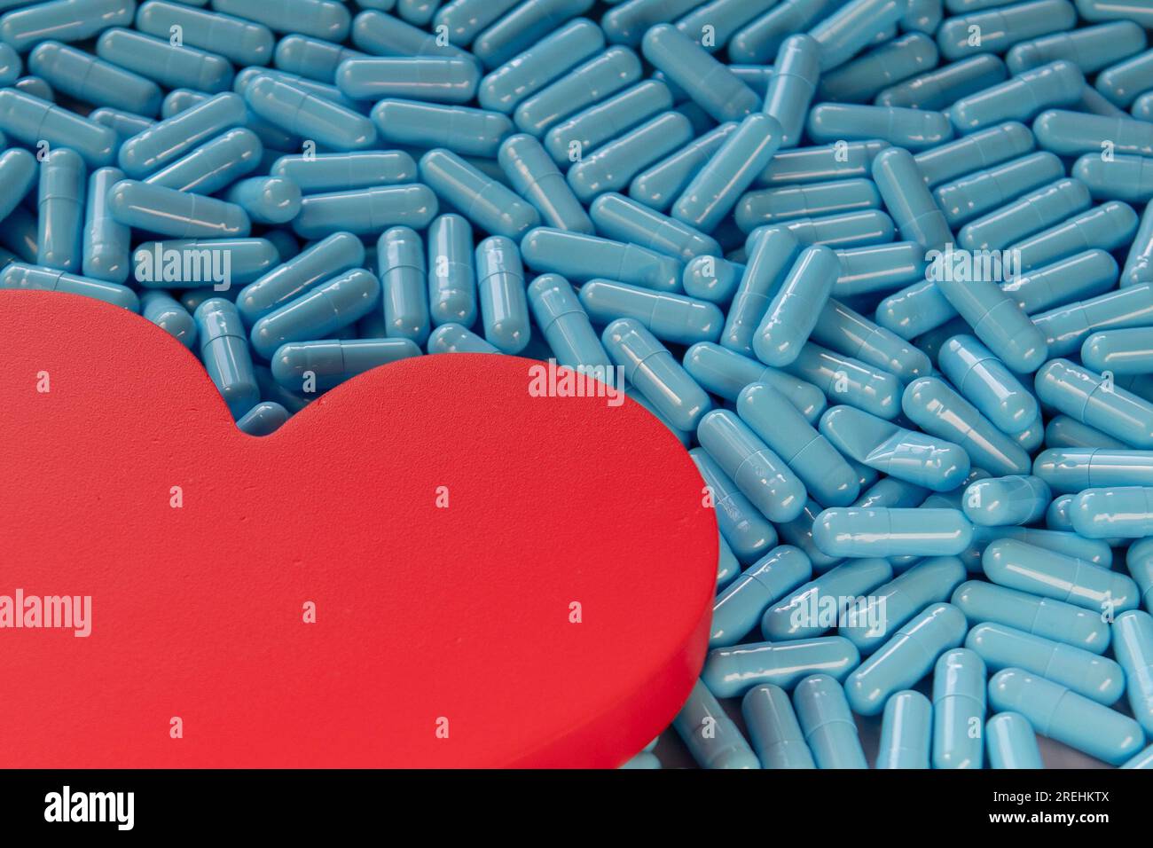 many blue medicine capsules and heart shape symbolizing medical ...