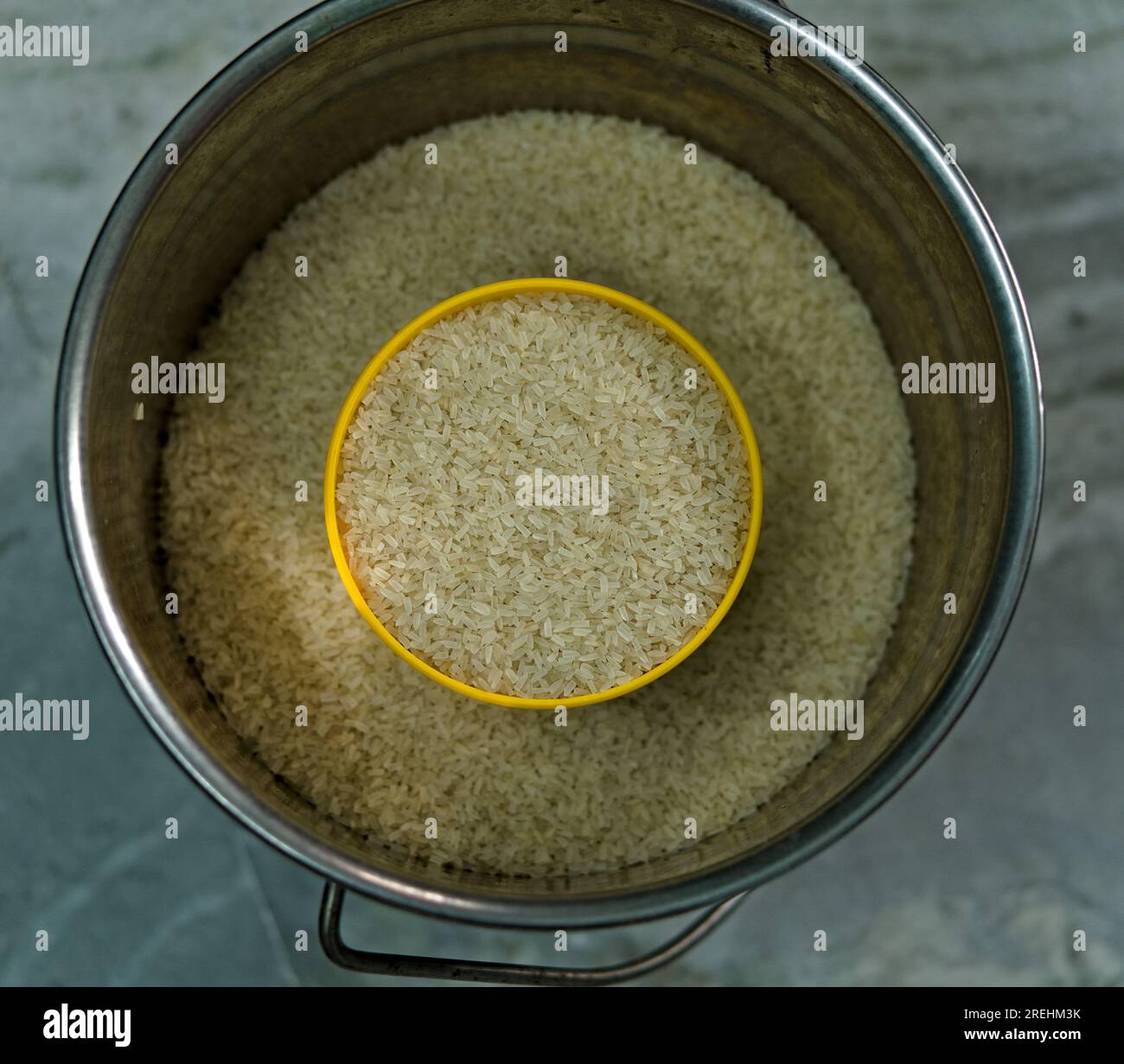 a cup of basmati rice in the centre of rice bucket Stock Photo - Alamy