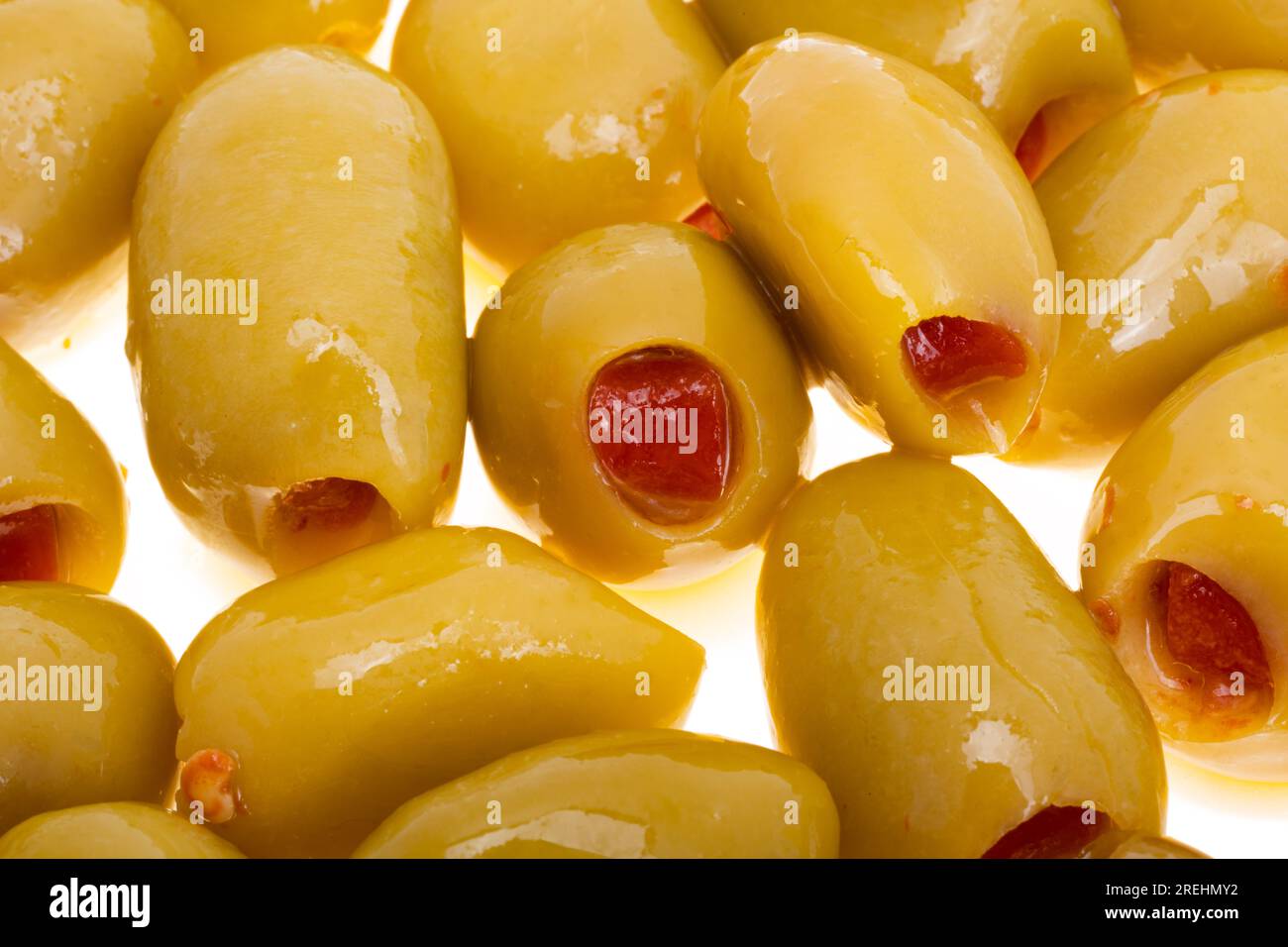 stuffed olives with pepper isolated on white background Stock Photo - Alamy