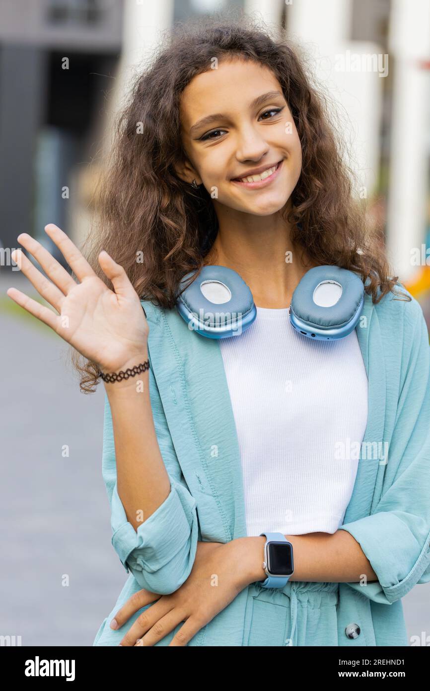 Hello. Preteen child kid smiling friendly at camera, waving hands ...