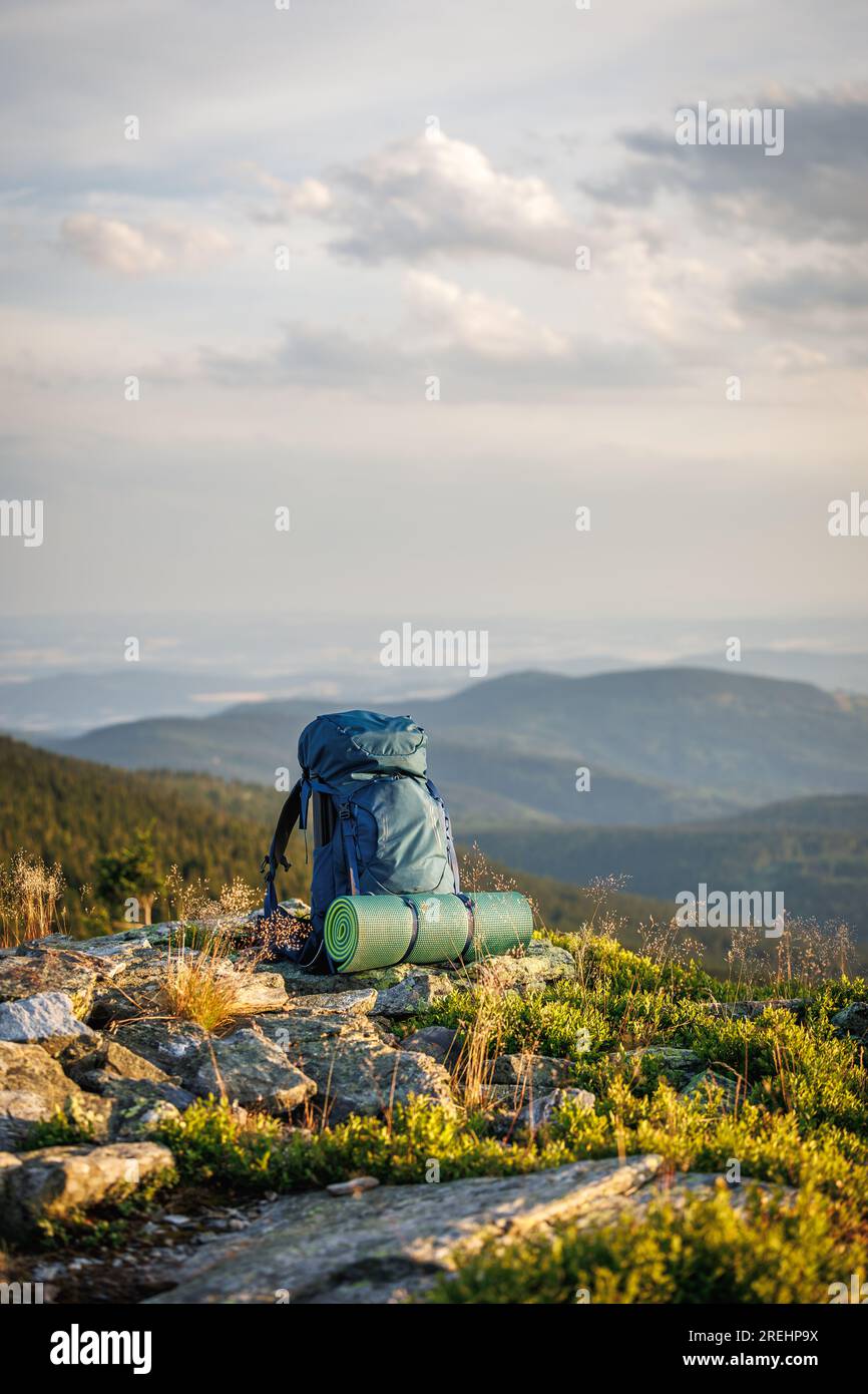 Hiking backpack with mat on rock during trek in mountains. Camping and ...