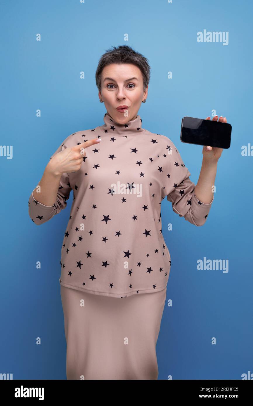 pretty cute young european woman with short dark hair shows ads on ...