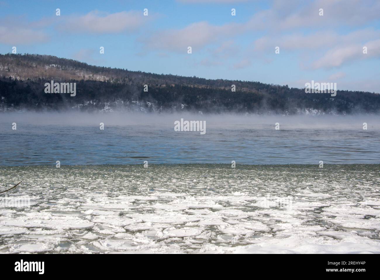 Winter scene with a lake and ice steam Stock Photo - Alamy