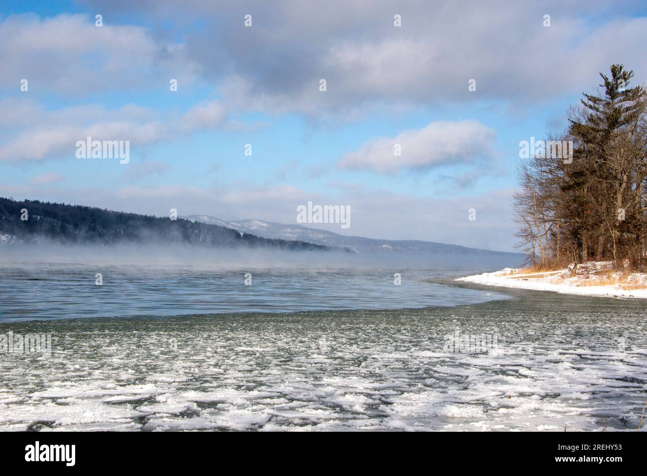 Winter scene with a lake and ice steam Stock Photo - Alamy