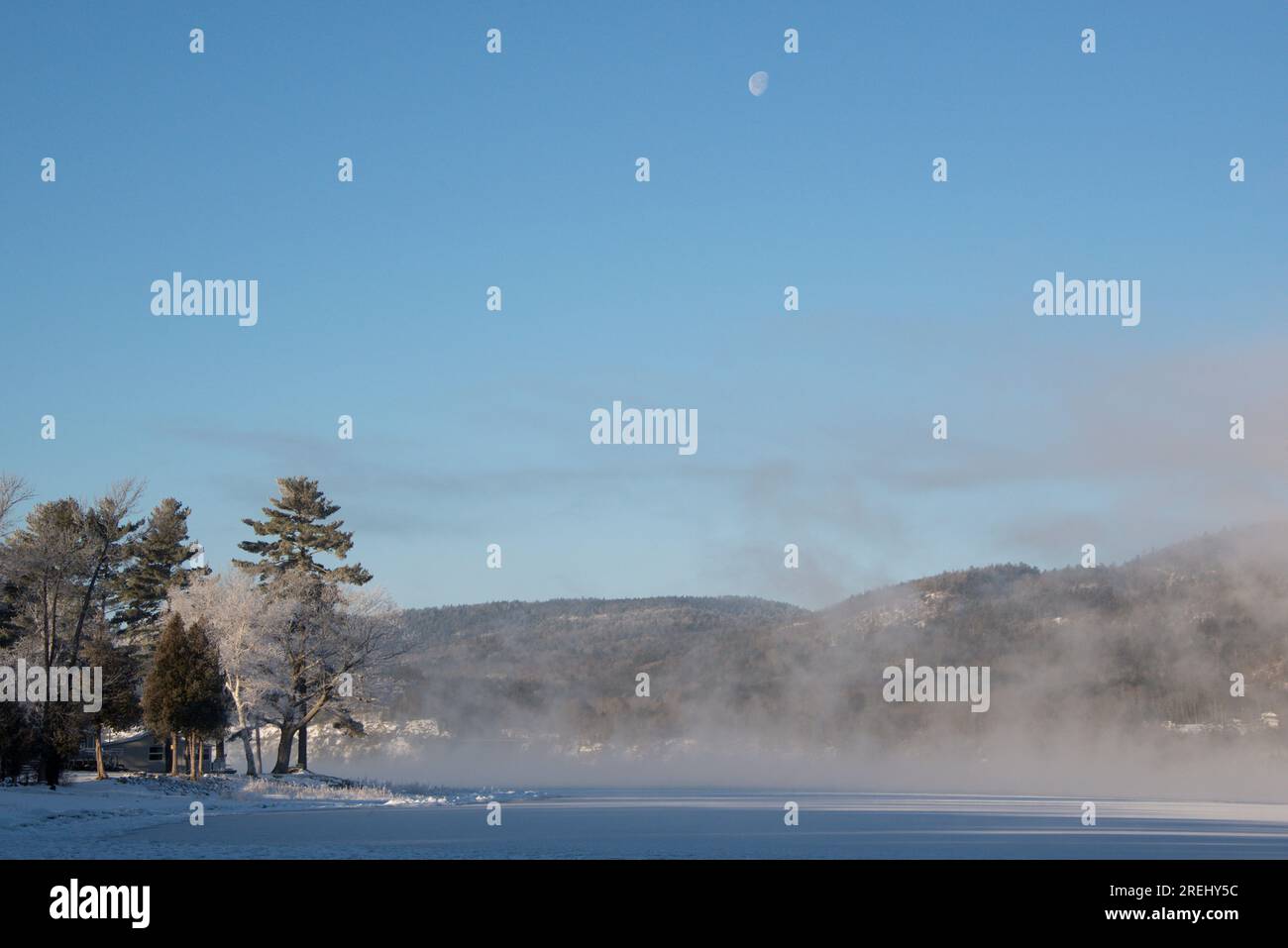 Winter scene with a lake and ice steam Stock Photo - Alamy