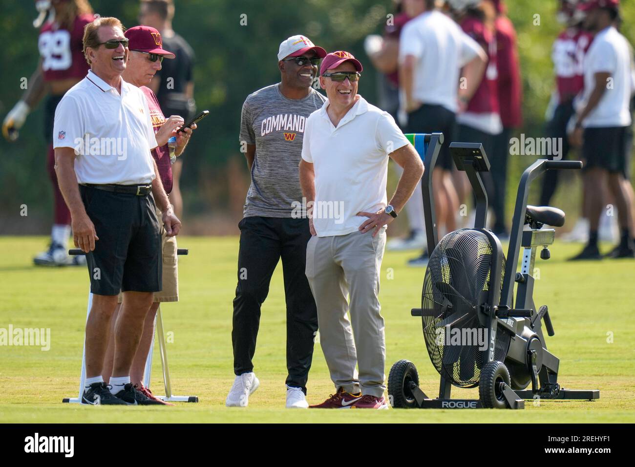 Washington Commanders owner Josh Harris, right, laughs with Joe ...