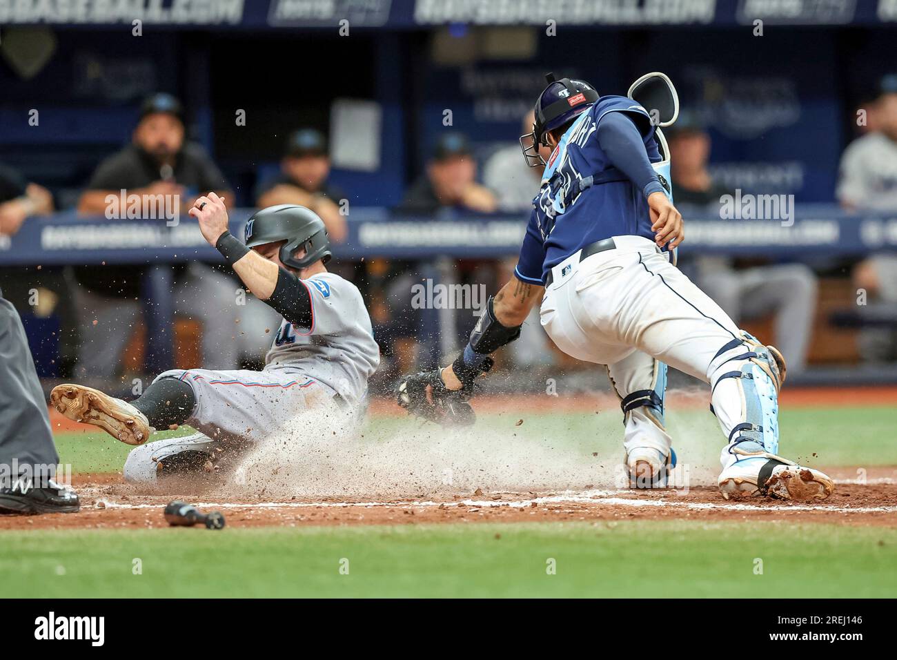 Miami Marlins' Jon Berti slides behind Tampa Bay Rays catcher Christian ...
