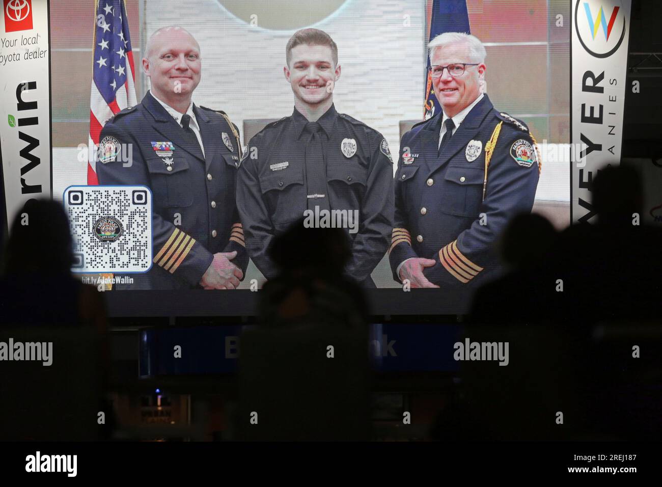Guests watch the video board as a photo of Fargo Police Assistant Chief ...